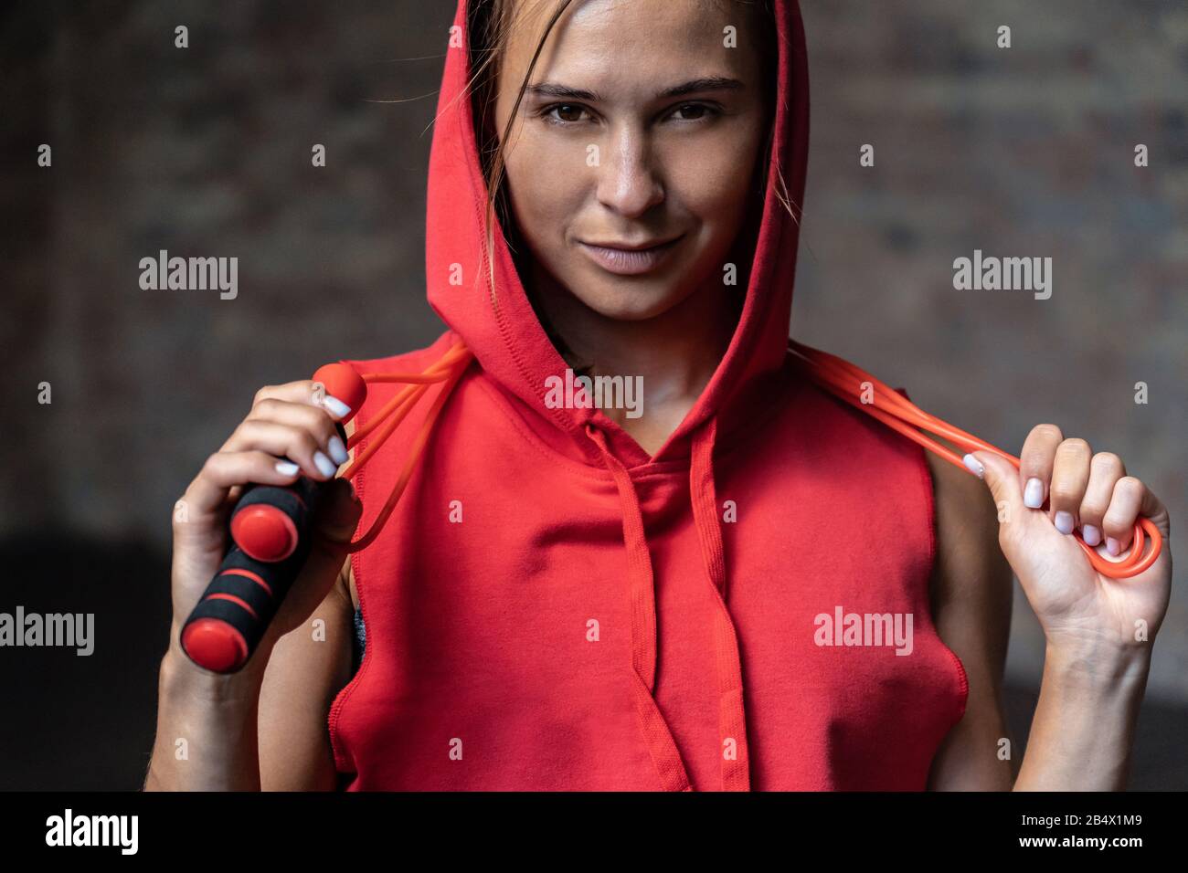 Pretty smiling sporty young woman hold skipping rope around neck Stock ...