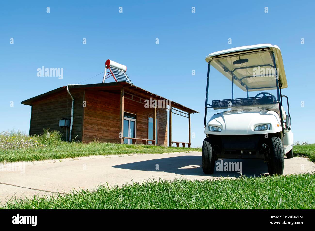 White golf carts at the green golf course Stock Photo - Alamy