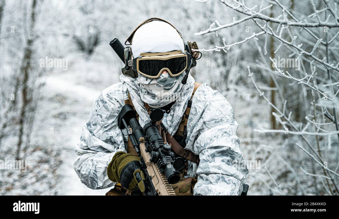 Airsoft man in white camouflage uniform and machinegun with optical ...