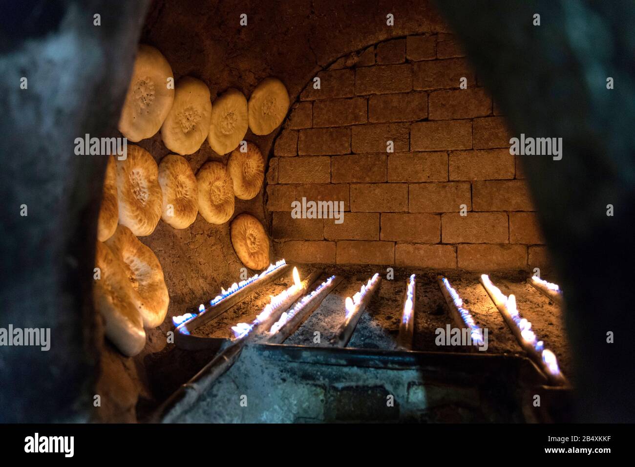 Baking traditional uzbek bread in a small bakery in Bukhara, Uzbekistan ...