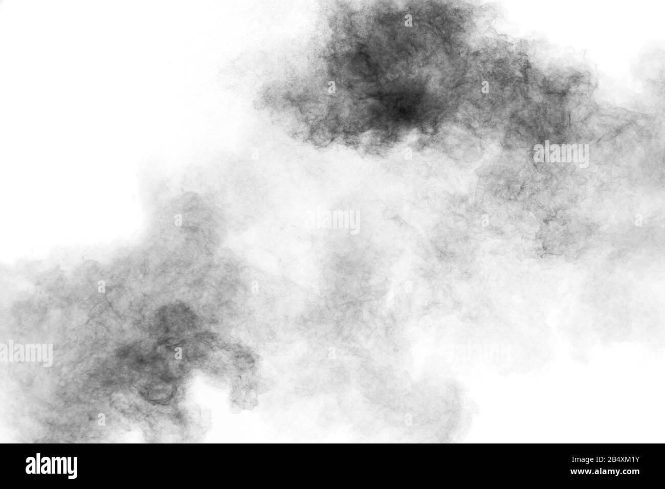 Black powder explosion against white background.Charcoal dust particles ...