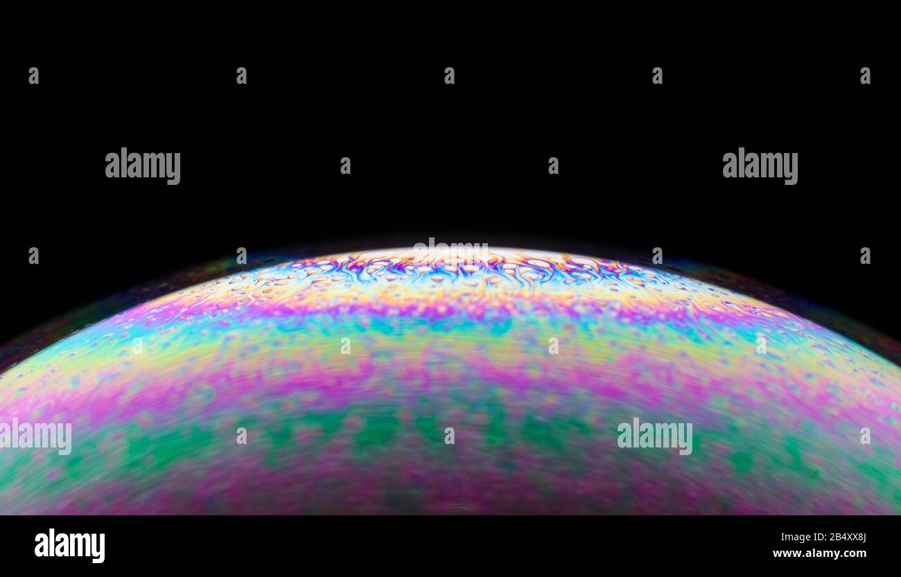 Macro of colorful iridescent soap bubble with abstract patterns and ...