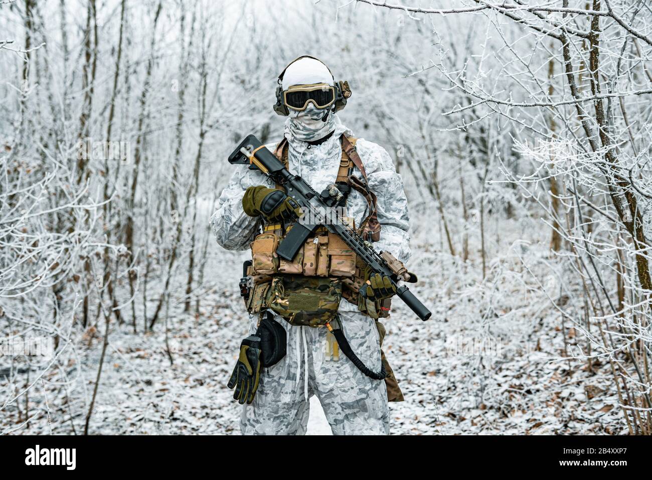 Military man in white camouflage uniform with machinegun. Soldier in ...