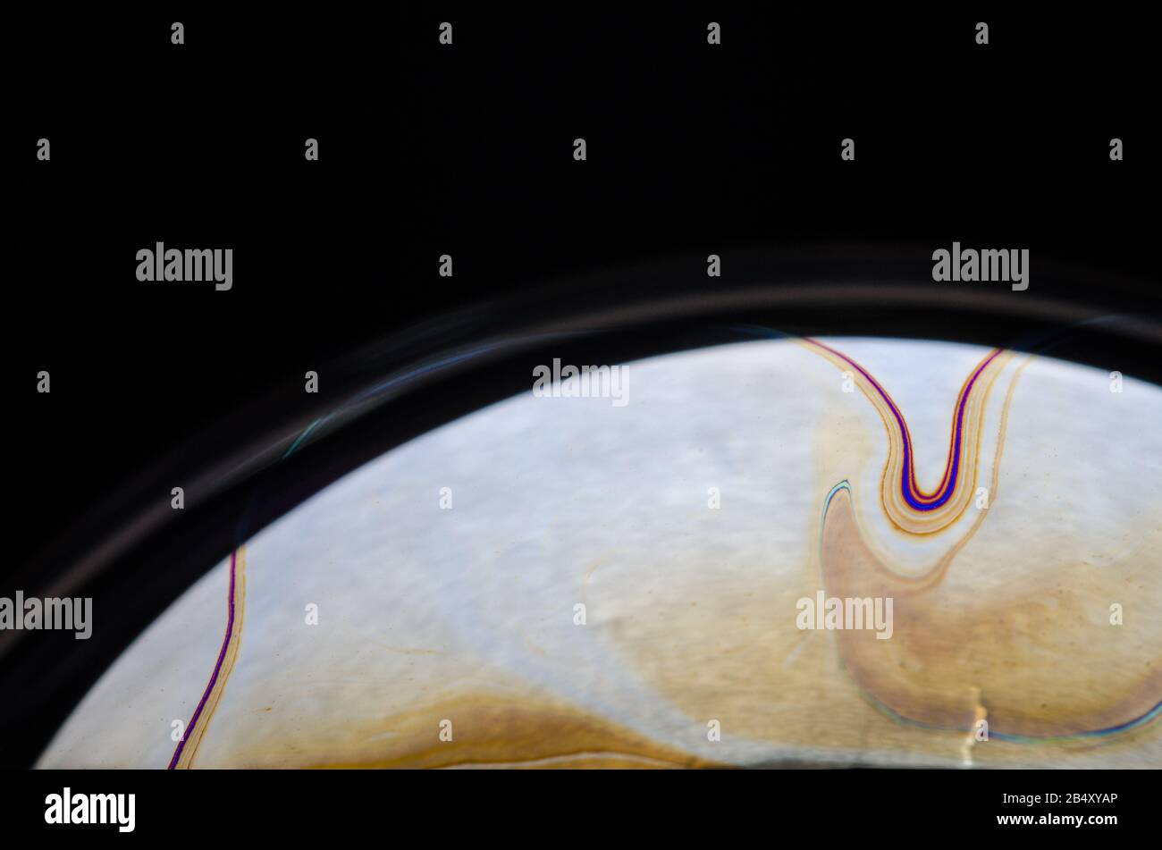 Macro of colorful iridescent soap bubble with abstract patterns and ...