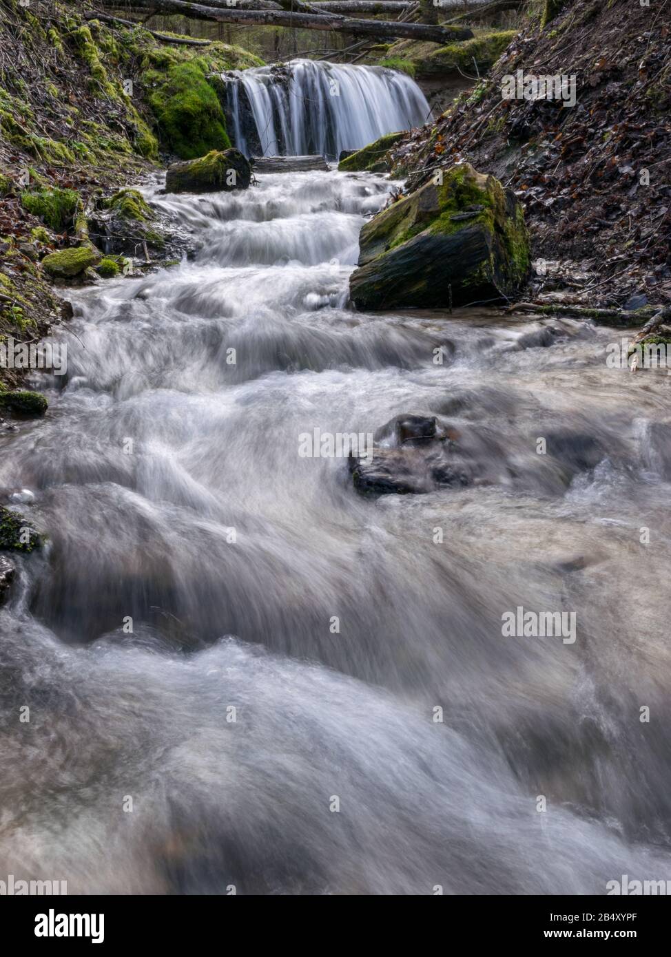 Blurred abstract background of running water, slow flow of water in a ...