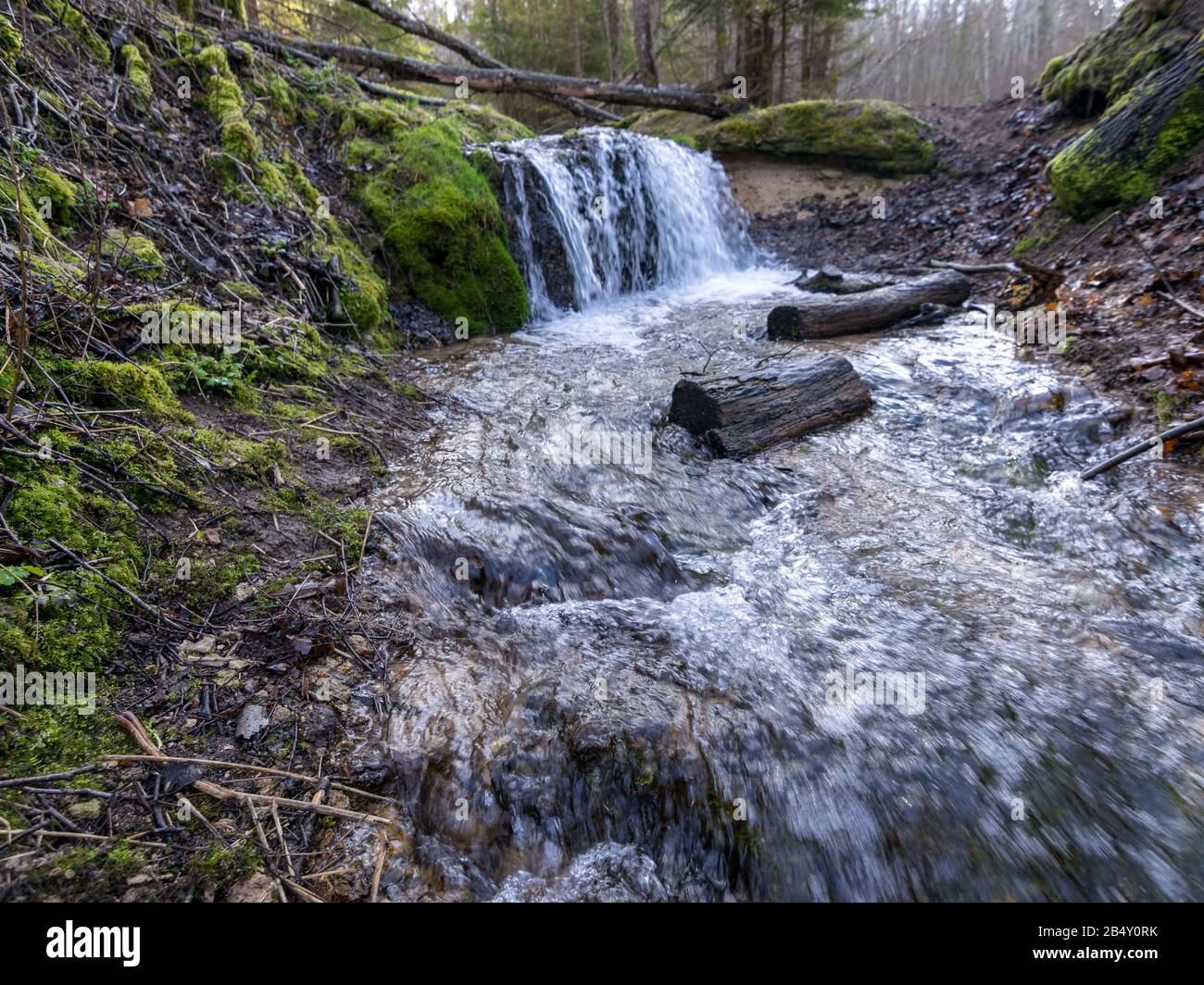 Blurred abstract background of running water, slow flow of water in a ...