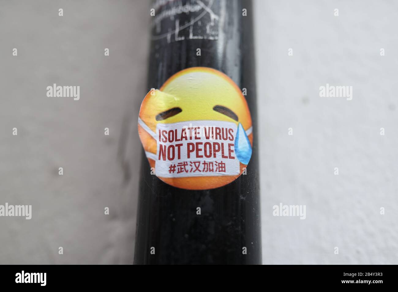 A sticker is seen showing the words 'Isolate virus not people,' in ...
