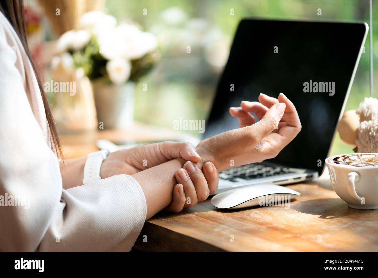 Closeup woman holding her wrist pain from using computer. Office ...