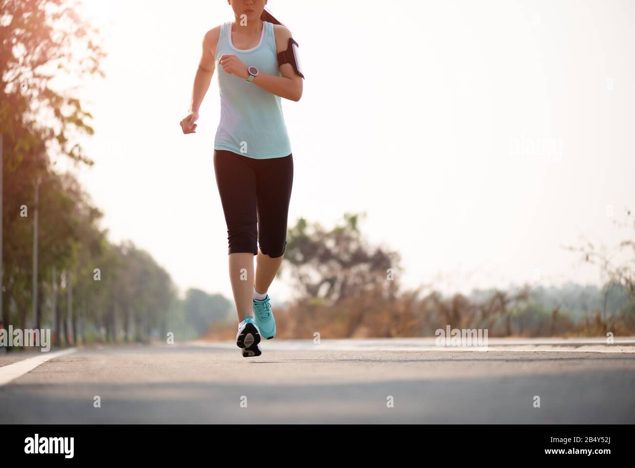 Closeup woman running towards on the road side. Step, run and outdoor ...