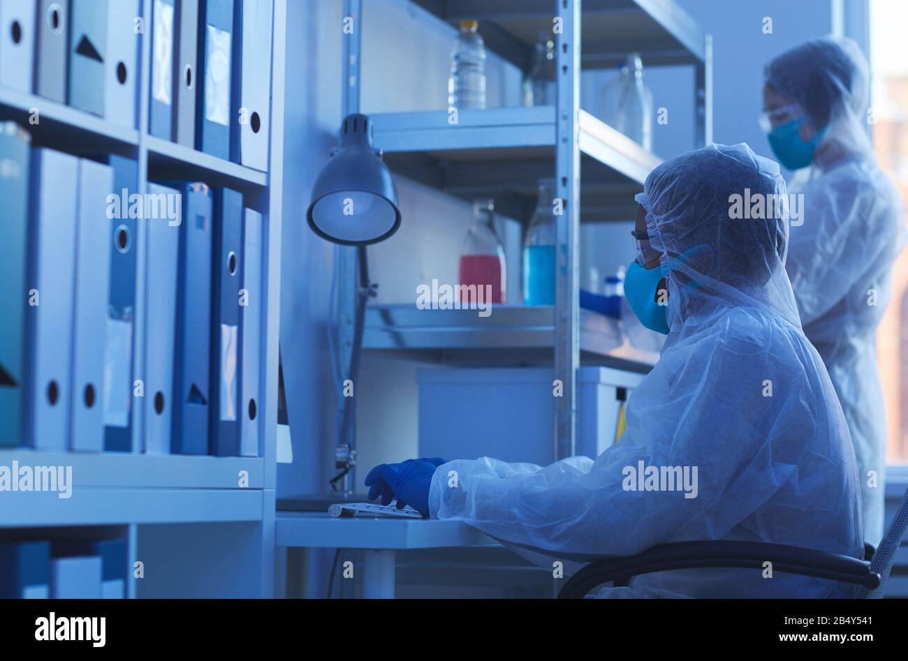 Horizontal side view shot of two unrecognizable medical scientists in ...