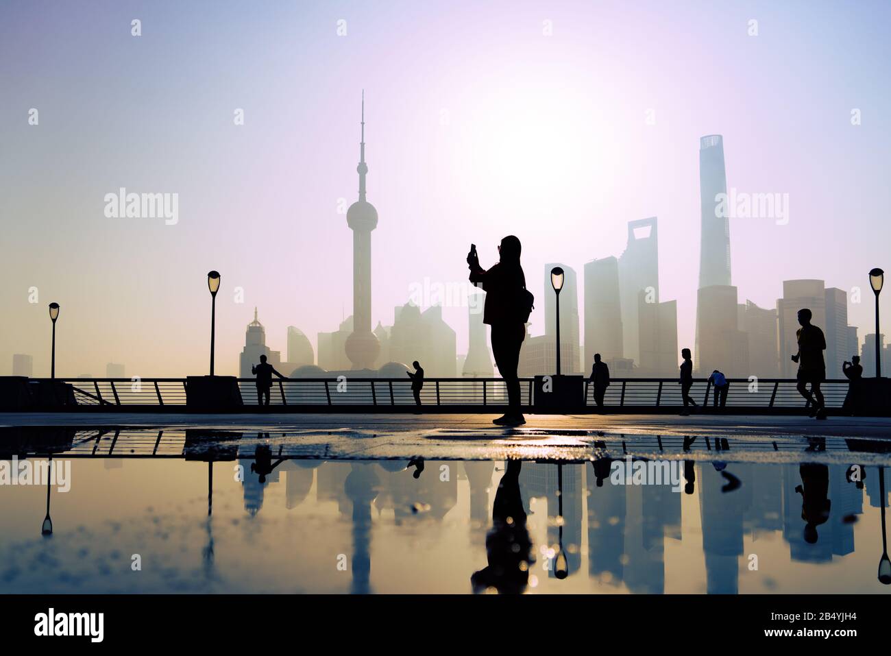 traveler take a photo of morning activity at the bund, huangpu ...