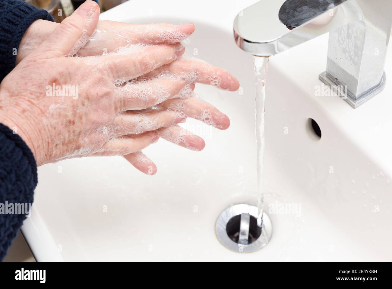 Person washing hands with water and soap in a sink Stock Photo - Alamy