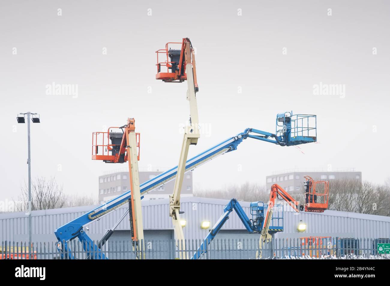 Access platform equipment powered high in sky in blue orange and yellow ...