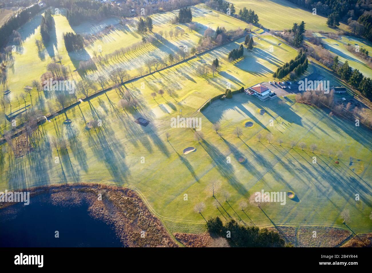 Aerial view of links golf course during summer showing green and ...