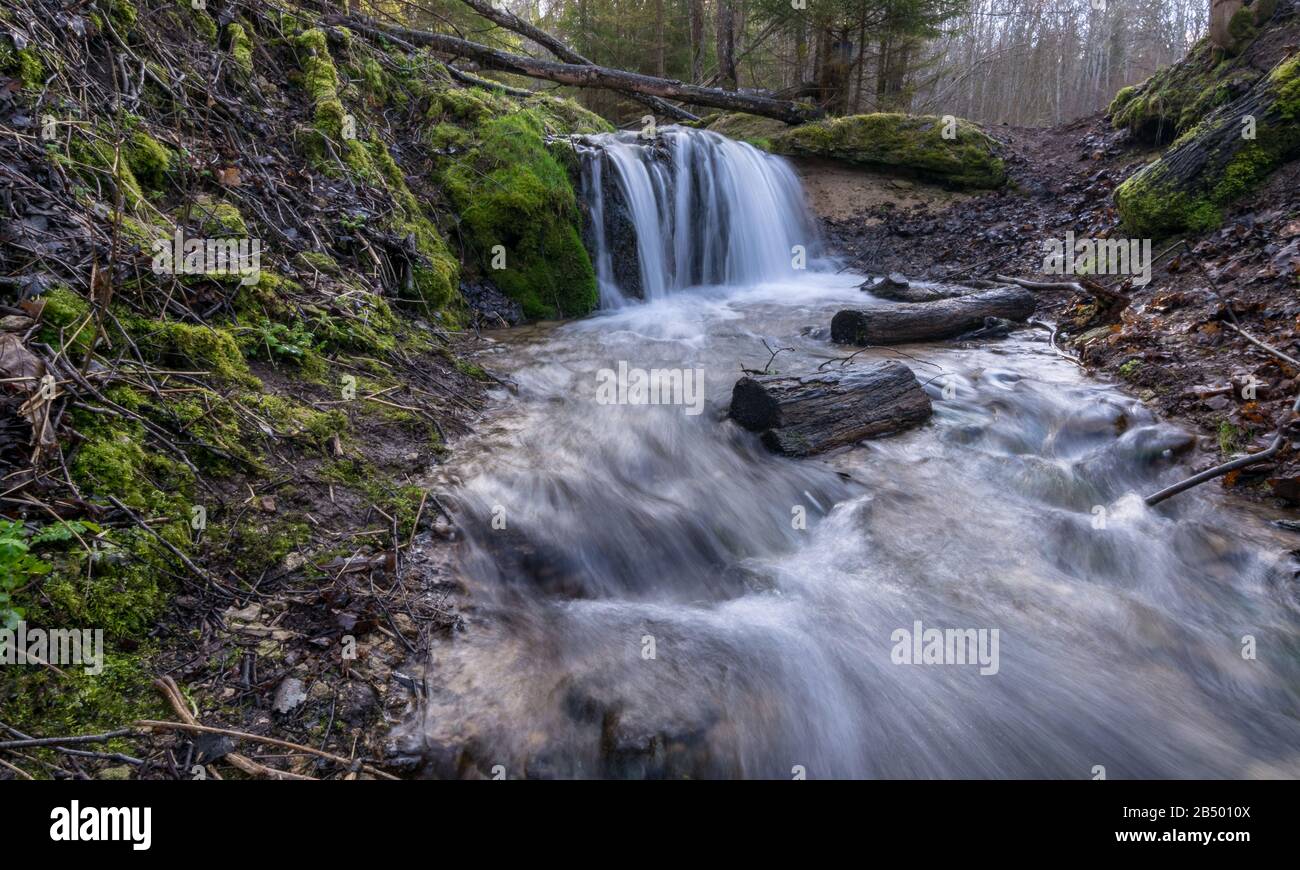 Blurred abstract background of running water, slow flow of water in a ...