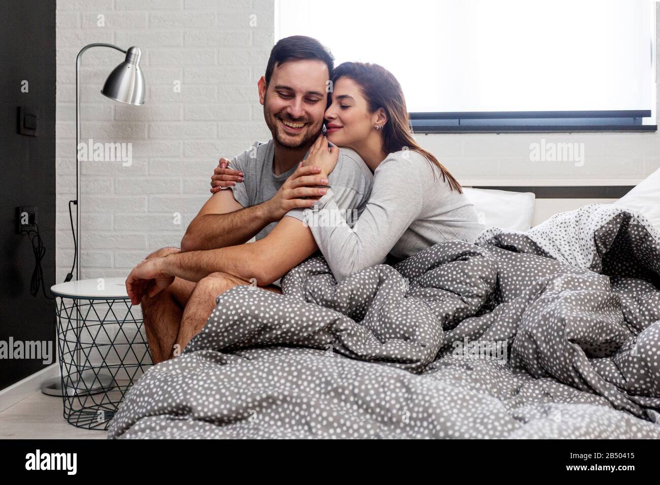 Couple in bed early in the morning Stock Photo - Alamy