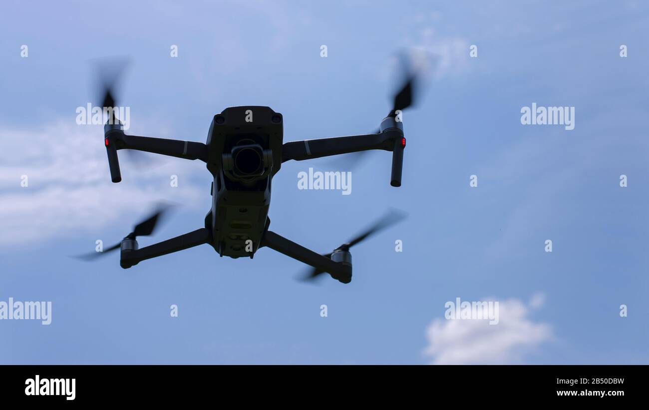 Drone in flight with camera Stock Photo - Alamy