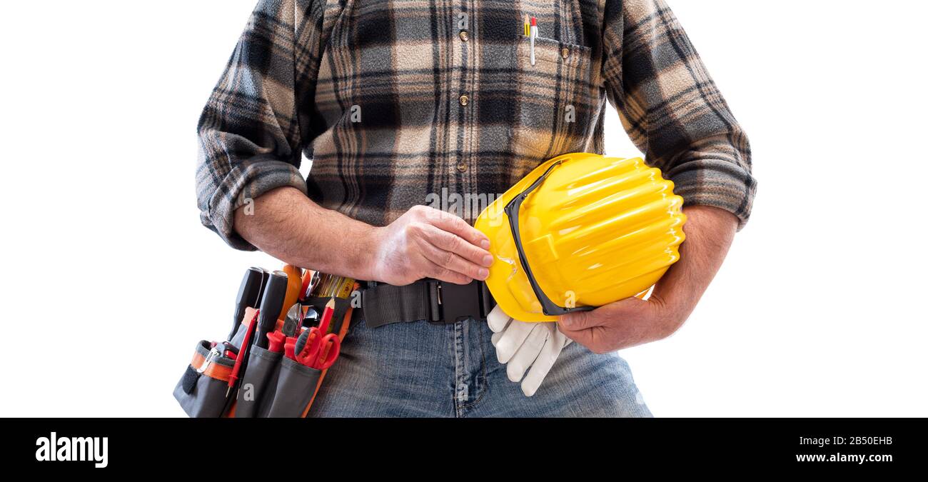 Carpenter electrician holds helmet and protective goggles in hand ...