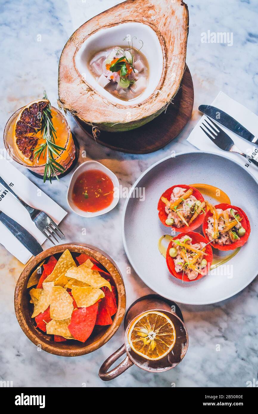 table setting full of latin dishes such as ceviche, tortilla chips ...