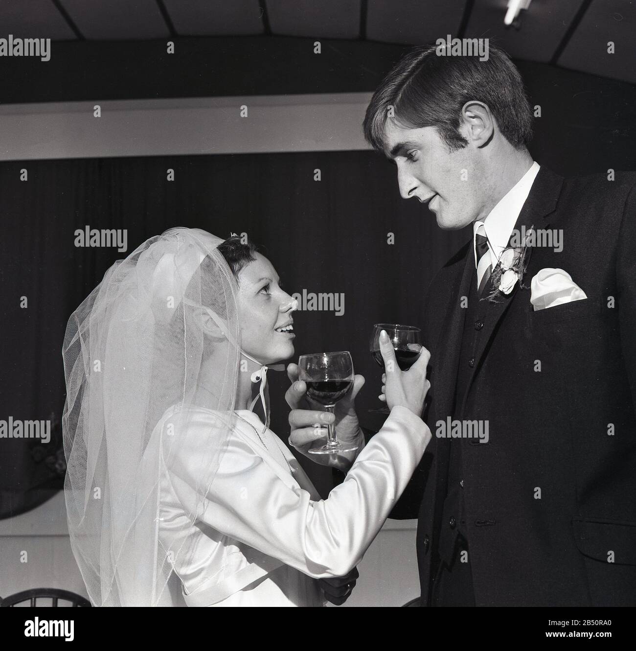1960s, historical, newly married couple, a bride in her dress and veil ...