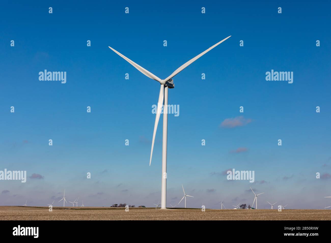 Wind turbine, windmill with wind farm in background. Concept of clean ...