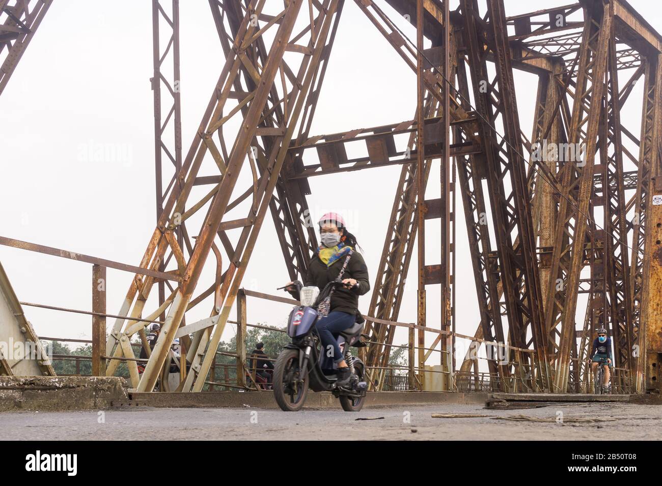 Hanoi Long Bien bridge - Woman motorist rides accross the historic Long ...