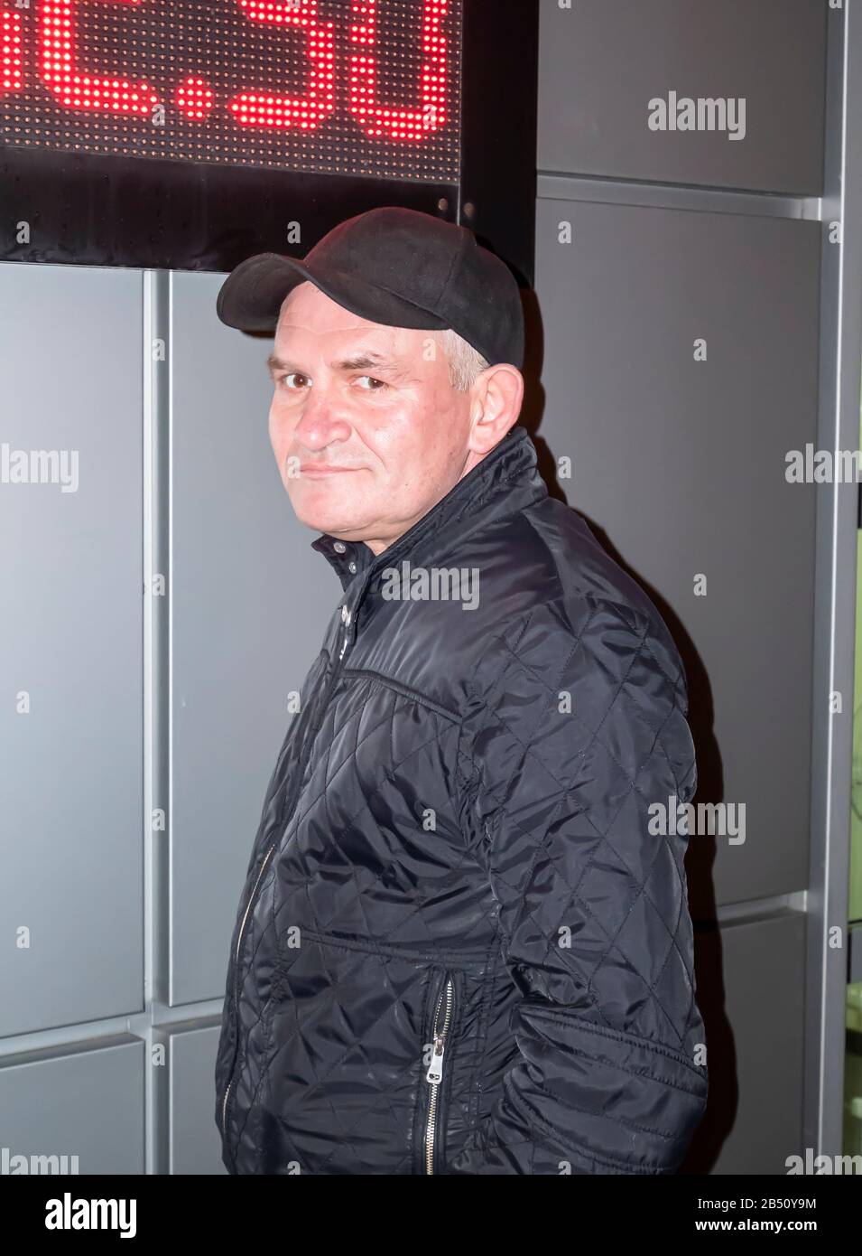 A man in a baseball cap on the street at night. People background image ...