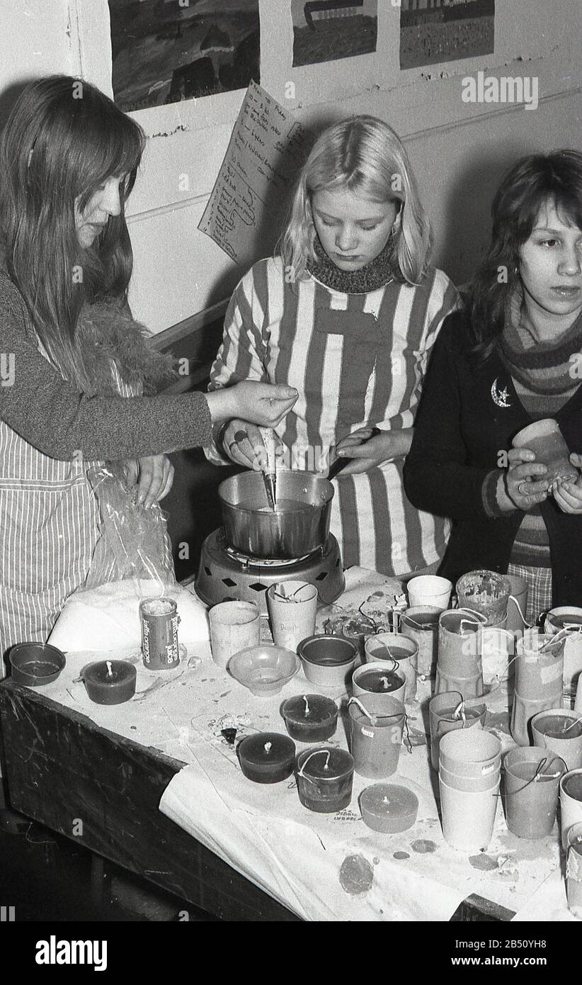1970s, historical, young women making candles, using a DIY candle ...