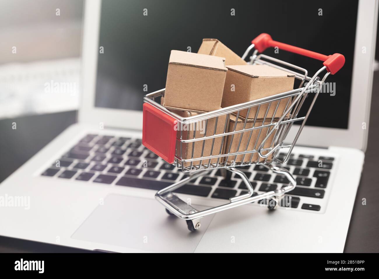 e-commerce, shopping trolley with paper boxes. Trade, selling via ...