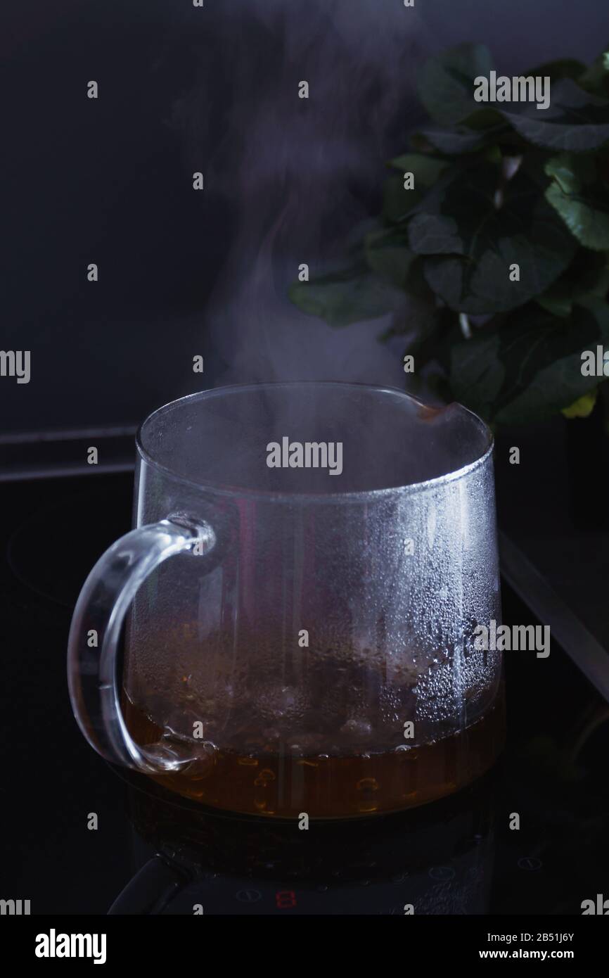 Natural infusion boiling in transparent glass pot on ceramic cooking ...