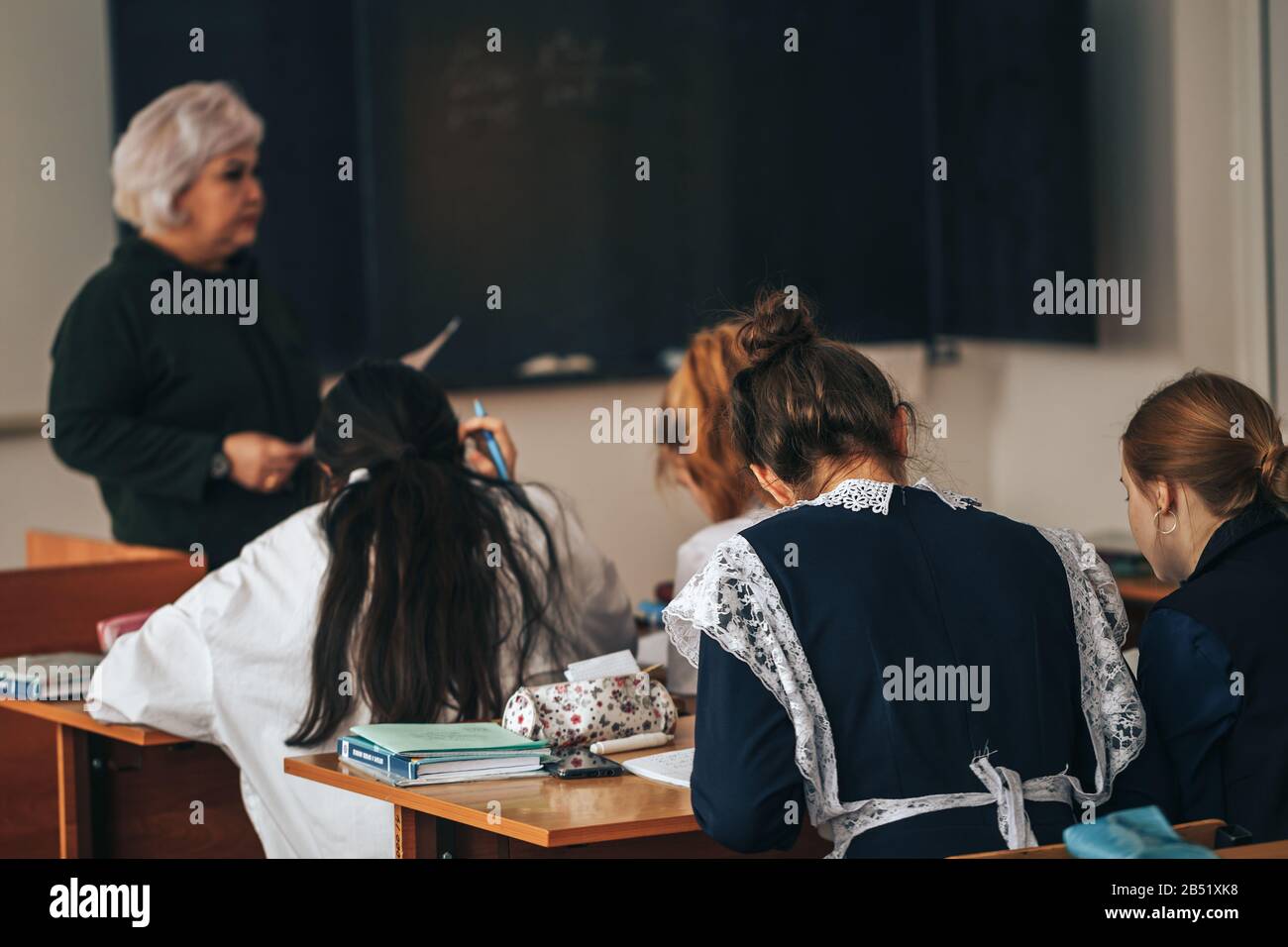 a classroom, a lecture, a lesson is going on, students are listening to ...