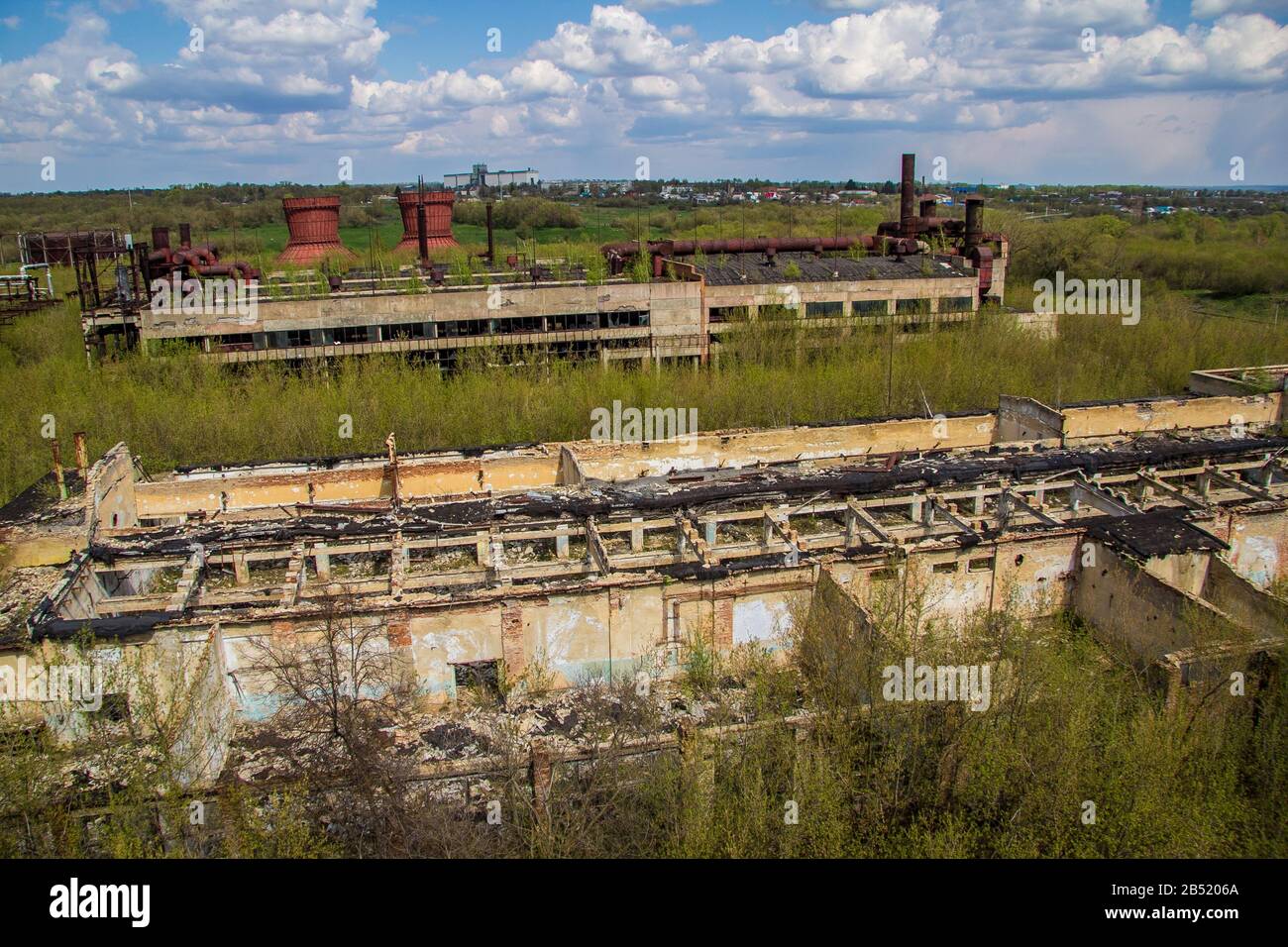 Old rusty overgrown abandoned industrial area Stock Photo - Alamy