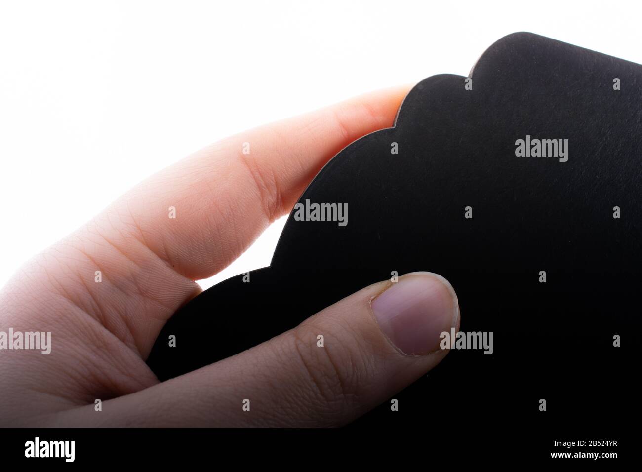 Black speech bubble shaped notice board in hand on white background ...