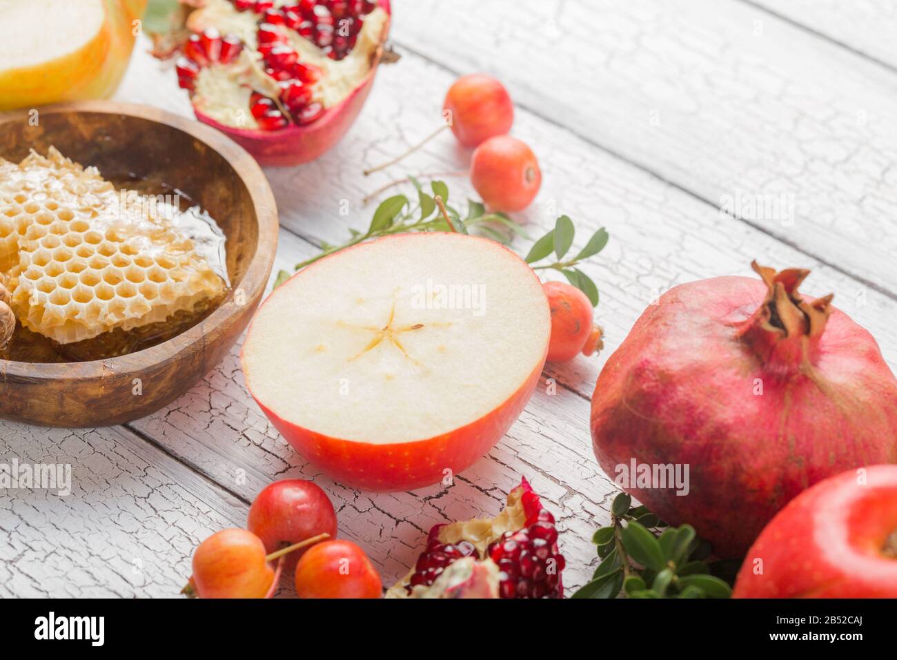 Rosh hashanah - jewish New Year holiday concept. Traditional symbols: Honey jar and fresh apples ...