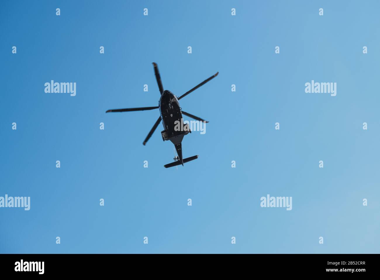Modern helicopter flying in the blue sky.Flying transport helicopter ...
