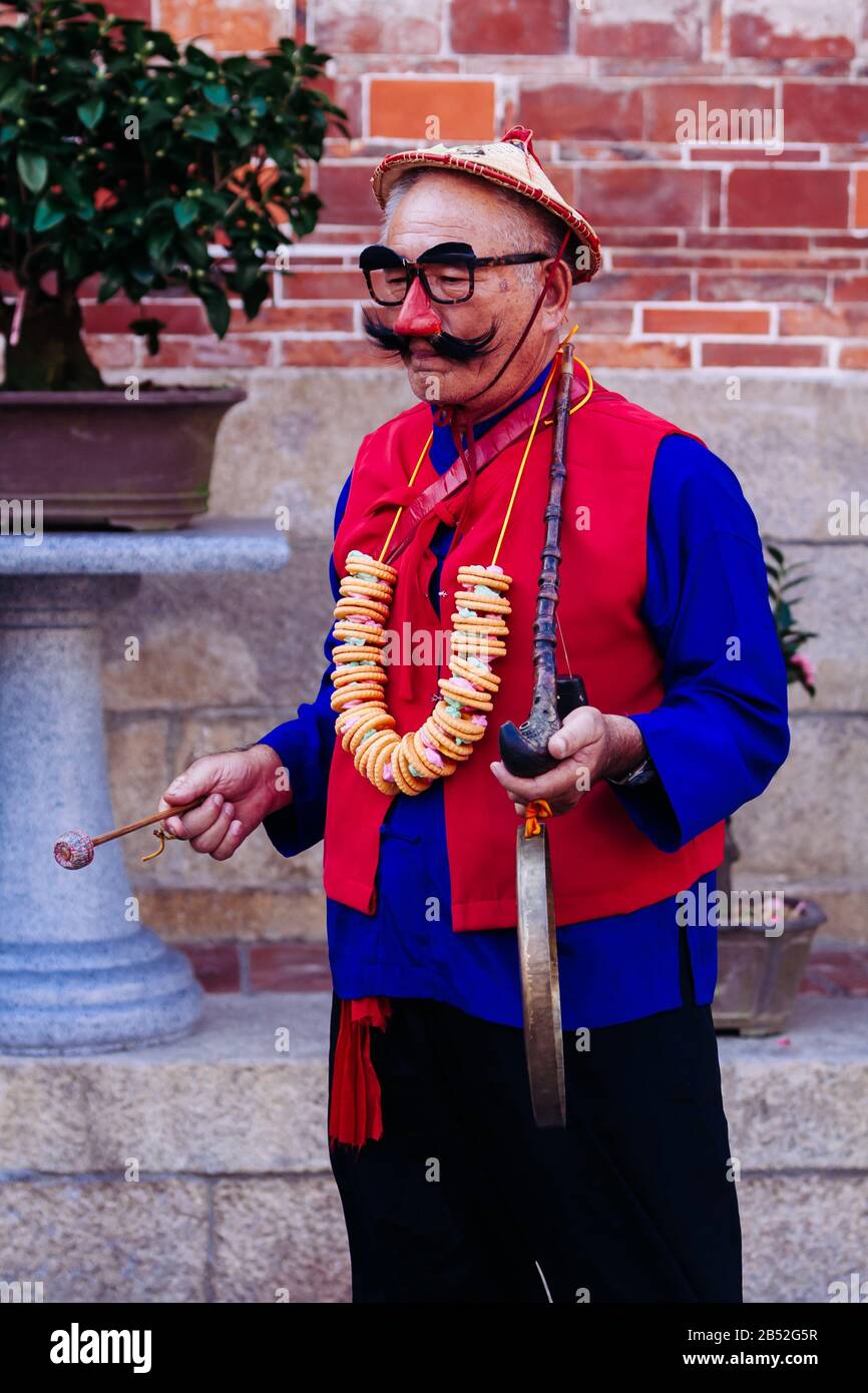 A man dressed in traditional costume as an ancient messenger "報馬仔" (Po ...