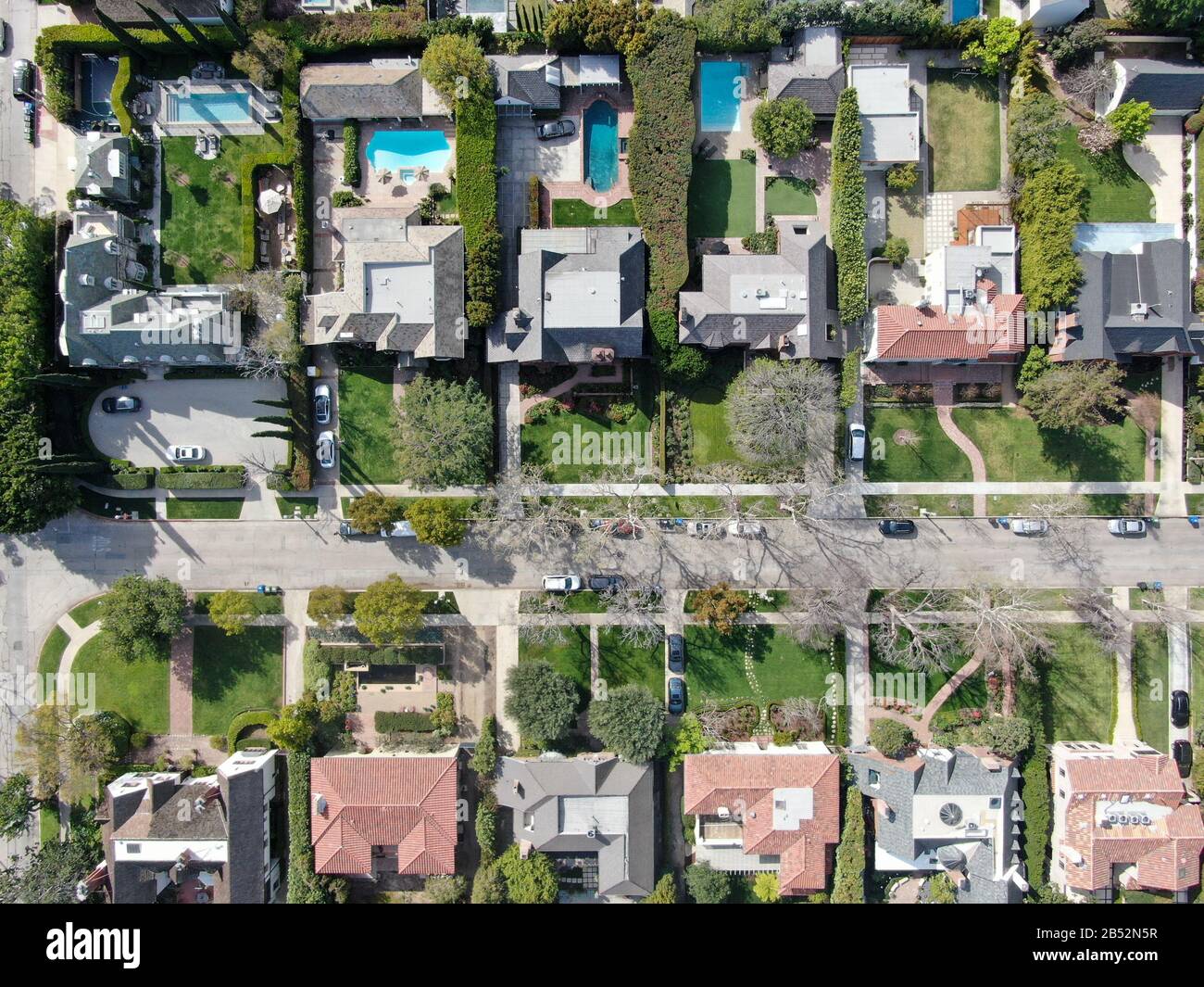 Aerial top view of wealthy area with big houses and small street in ...