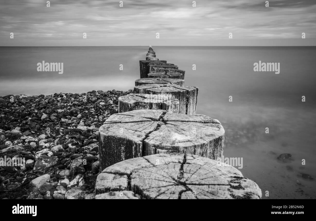 Abstract view of beach protection poles Stock Photo - Alamy