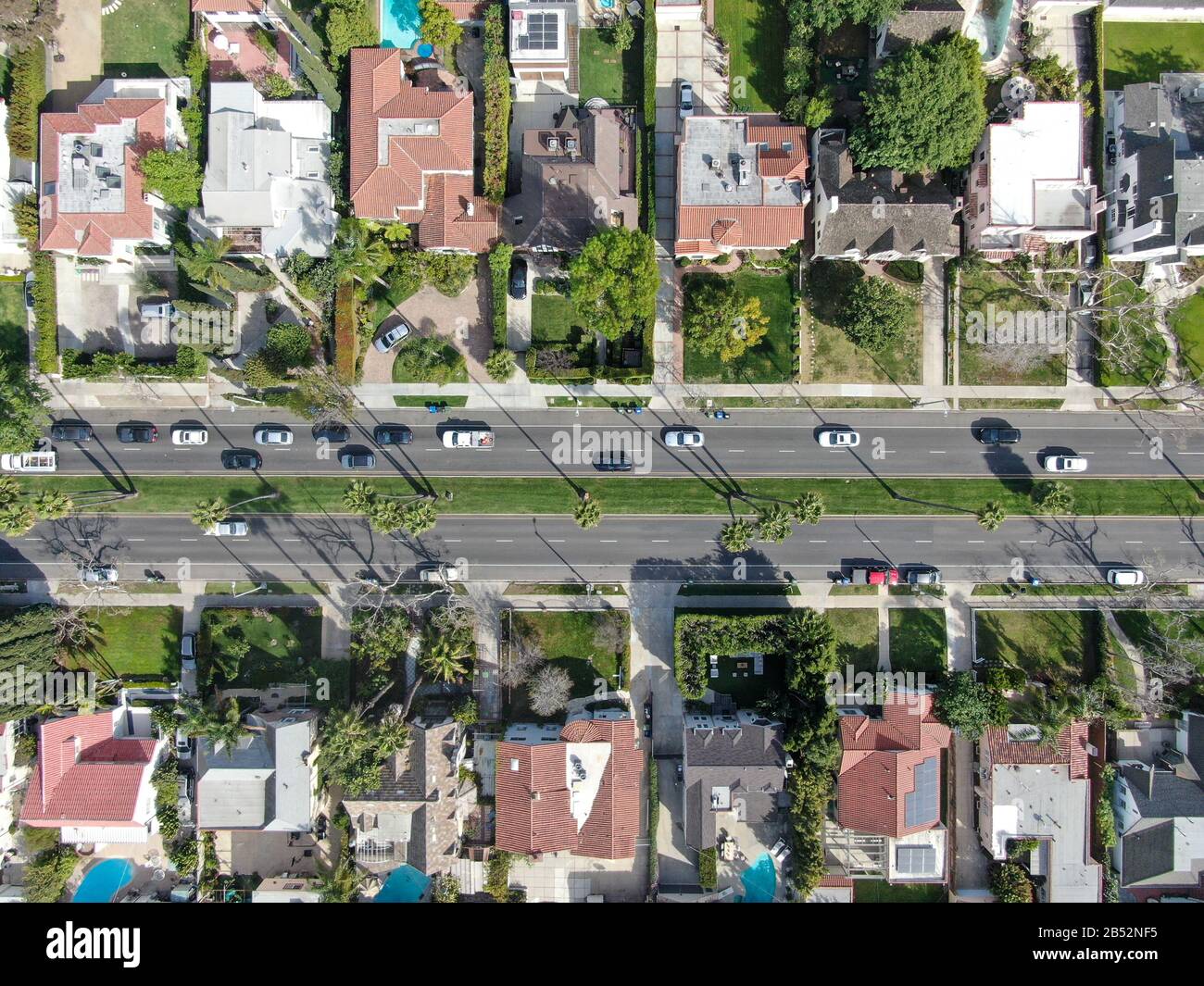 Aerial top view of wealthy area with big houses and small street in ...