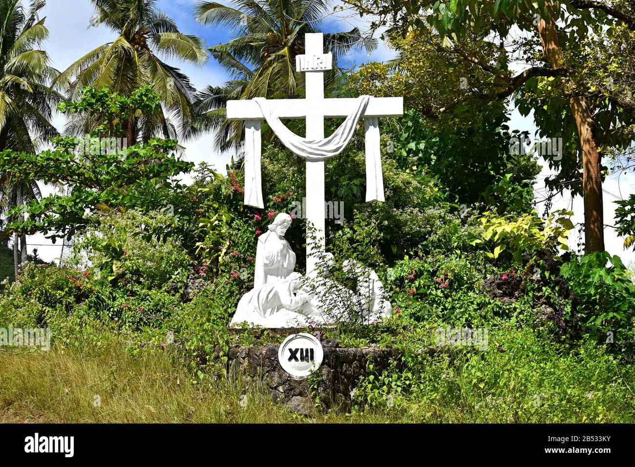 A Christian Cross And Statues Stock Photo - Alamy