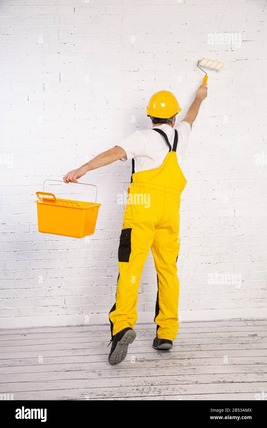 Painter on a construction site while doing his job Stock Photo - Alamy