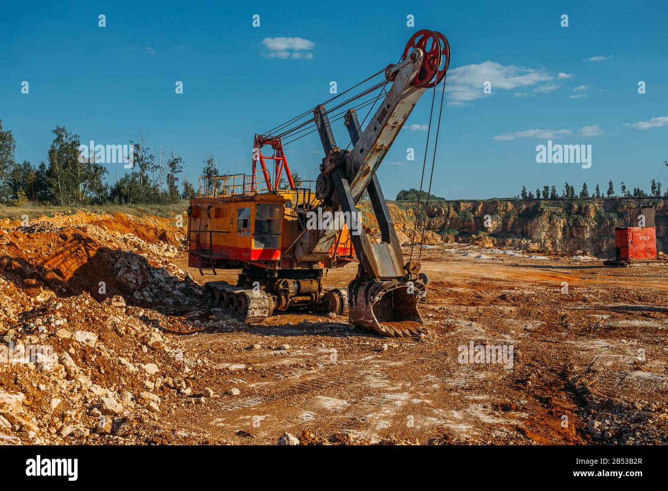 Excavator machine works in limestone pit quarry Stock Photo - Alamy