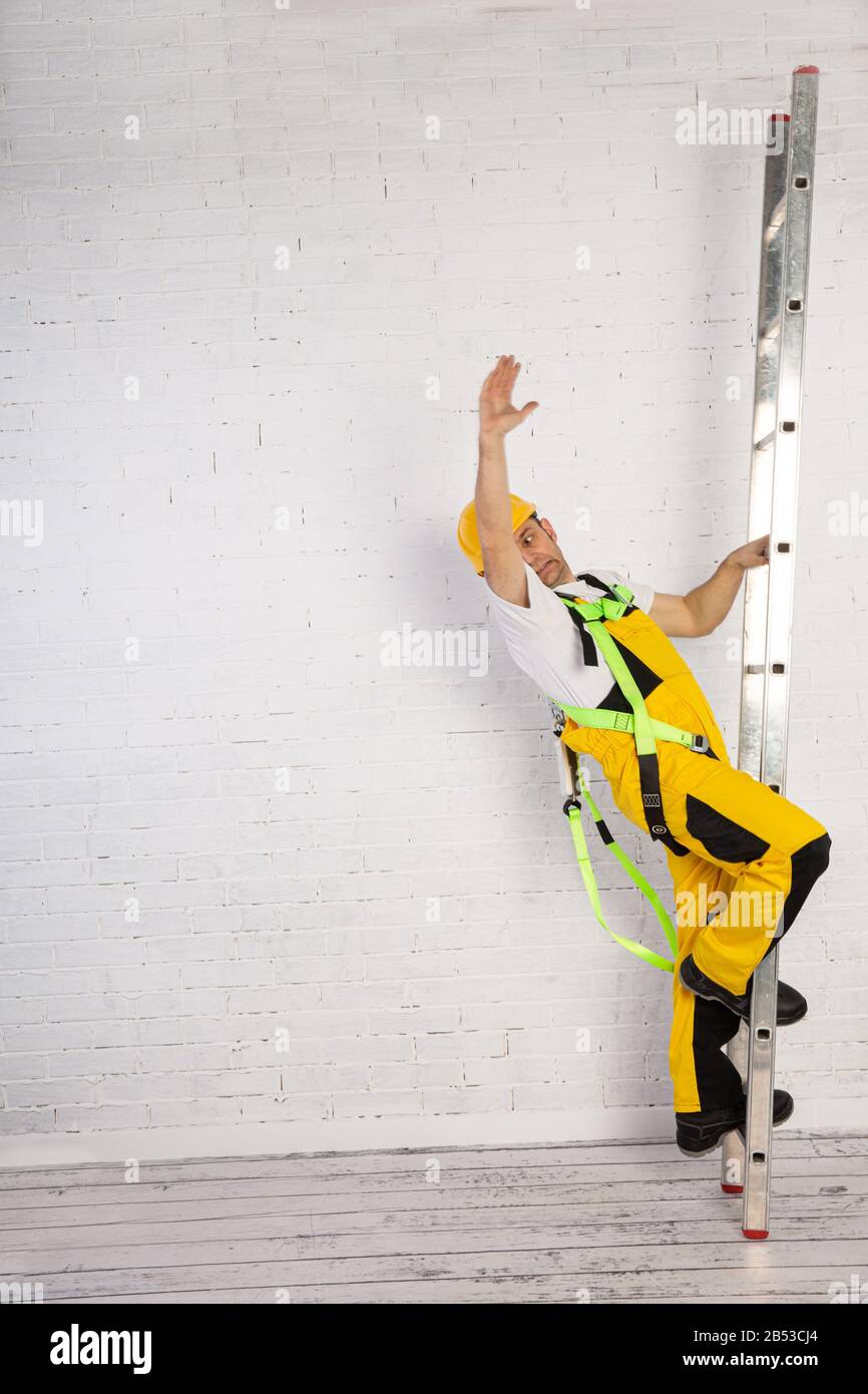 Irresponsible use of a ladder during construction work Stock Photo - Alamy