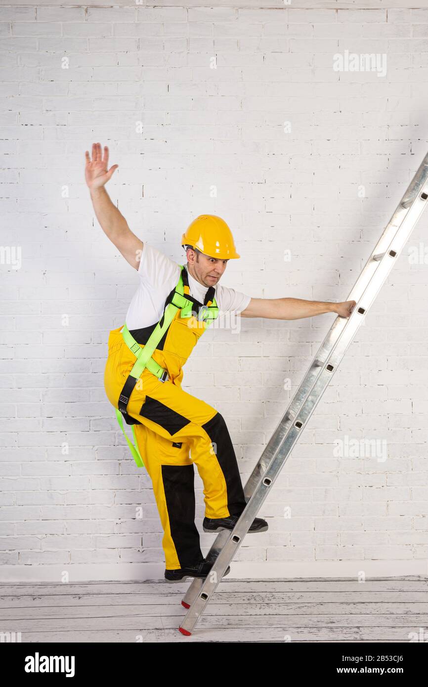 Irresponsible use of a ladder during construction work Stock Photo - Alamy