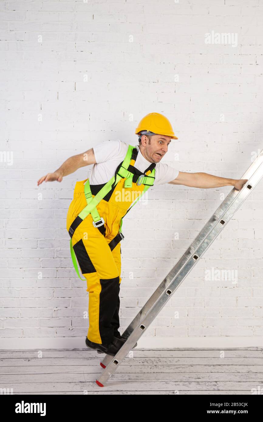 Irresponsible use of a ladder during construction work Stock Photo - Alamy