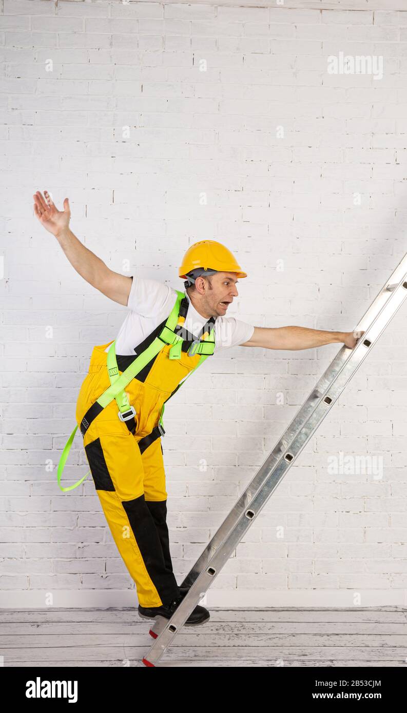 Irresponsible use of a ladder during construction work Stock Photo - Alamy