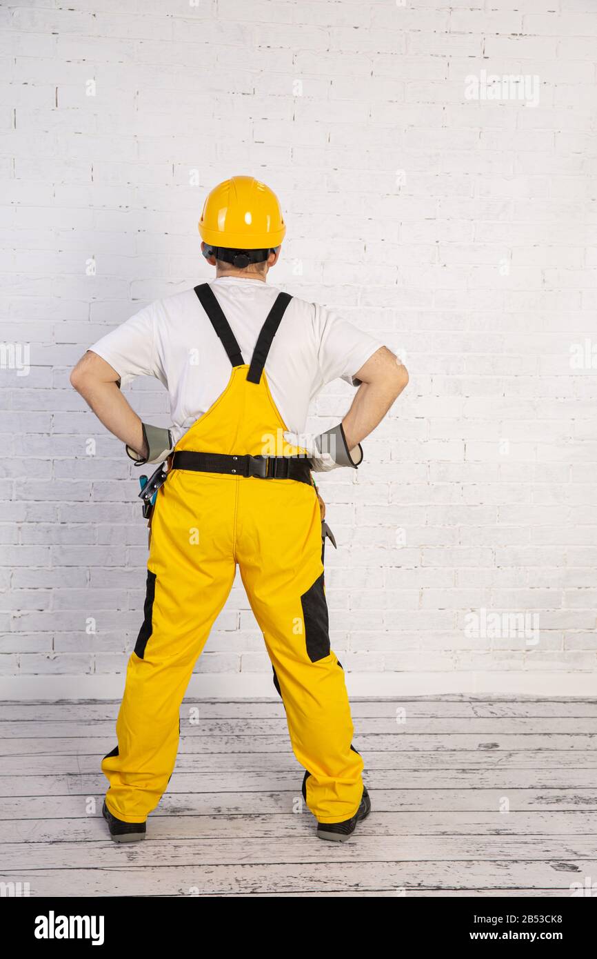Irresponsible use of a ladder during construction work Stock Photo - Alamy