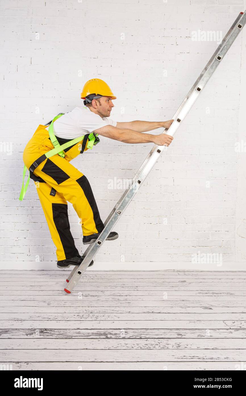 Irresponsible use of a ladder during construction work Stock Photo - Alamy