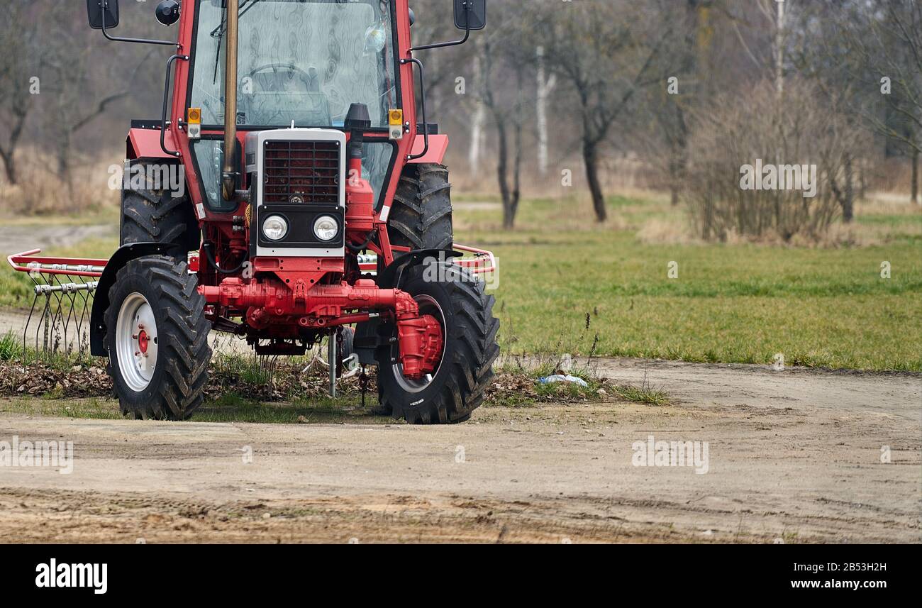 Small scale farming with tractor and plow in field Stock Photo - Alamy