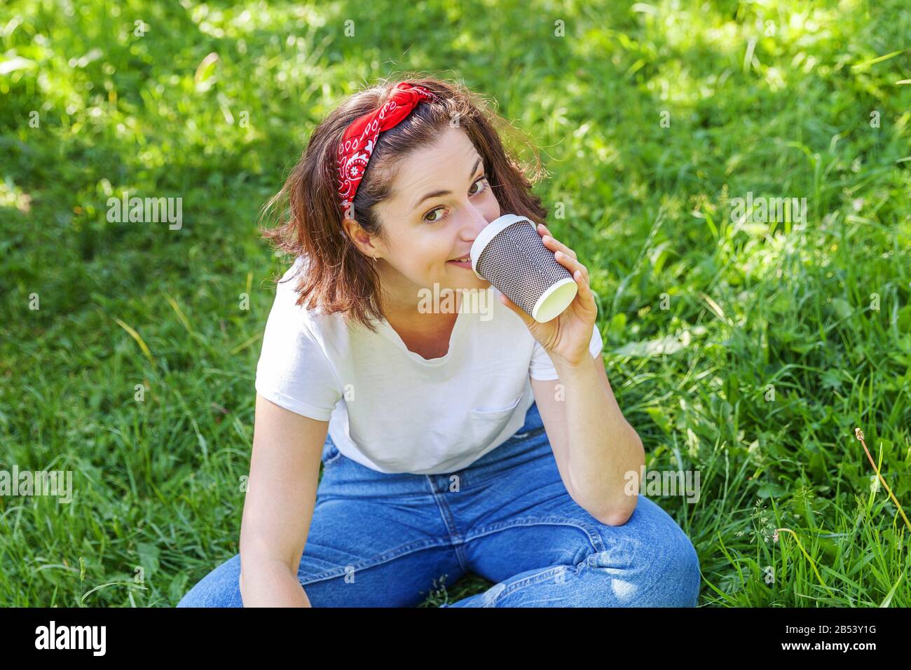 Happy girl smiling outdoor having lunch break. Beautiful young brunete ...